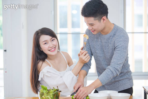 Asian couples making salads and eating cleanfood , healthy meals. Stay ...
