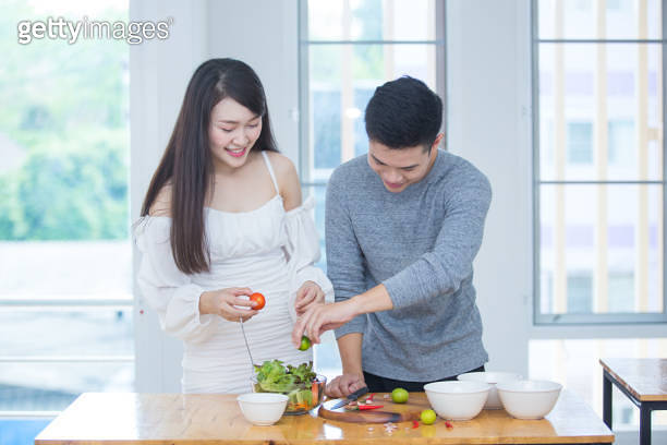 Asian couples making salads and eating cleanfood , healthy meals. Stay ...