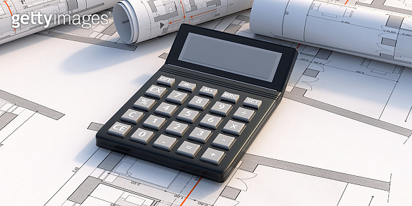 Calculator on blueprint plans background. Construction budget concept ...