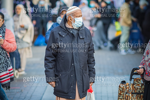 An Asian Muslim man (BAME community) wearing a mask while shopping at ...