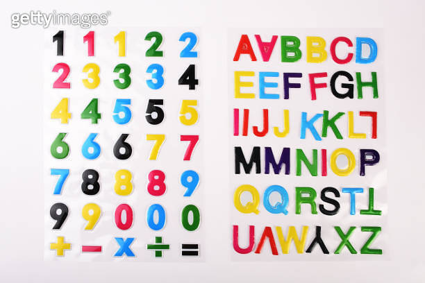 Multi colored alphabet letters and numbers sticker label on the white ...