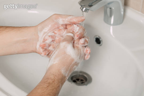 Hygiene concept. Washing hands with soap under the tap with water ...