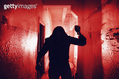 Silhouette of murderer with knife in hand. Scary thriller style in red ...