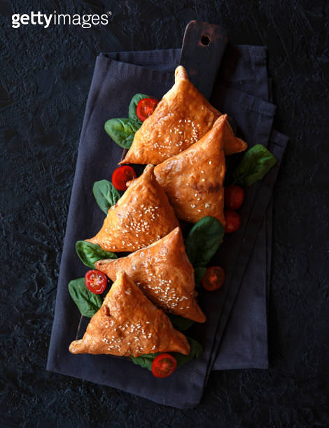 Samsa on a dark background. Traditional Eastern Uzbek pastries ...