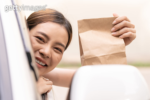 Asian woman holding food bag from drive thru service restaurant 이미지 ...