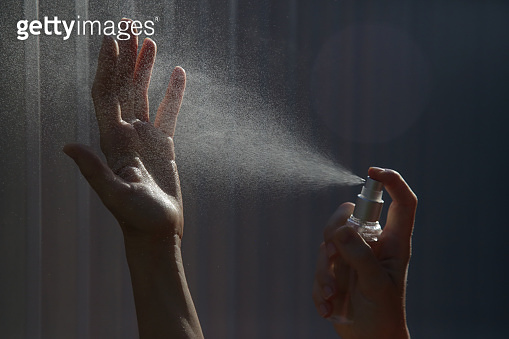 Hands spray. Antibacterial spray for hands. Woman spray hands sanitizer ...