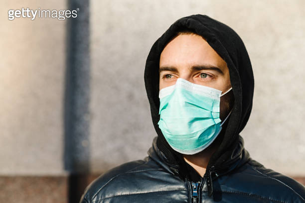 Coronavirus. Young man in city street wearing face mask protective for ...