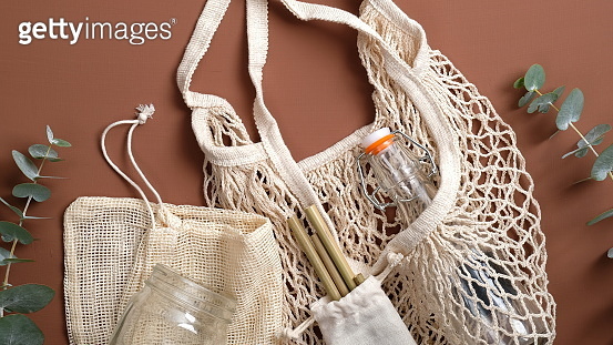 Zero waste concept. Set of eco friendly string bags, glass bottle and ...