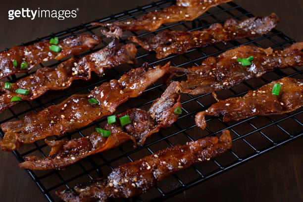 Roasted bacon in sweet maple syrup glazing topped with sesame seeds and ...