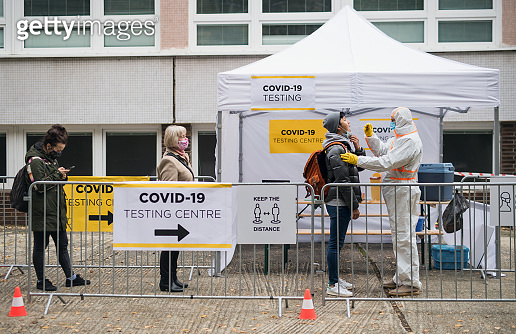 People waiting in covid-19 testing center outdoors on street ...