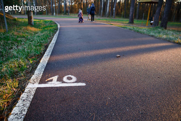 Running asphalt track in the forest with a mark of 10 meters ...