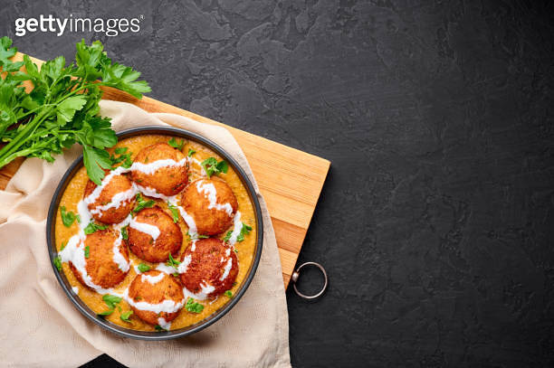 Malai Kofta Curry in black bowl at dark slate background. Malai Kofta ...