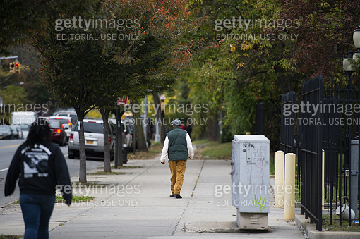 An African American man is walking on the streets of the Bronx borough ...