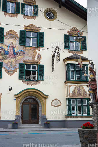 House in traditional Tyrol style with ancient wooden windows and blinds ...