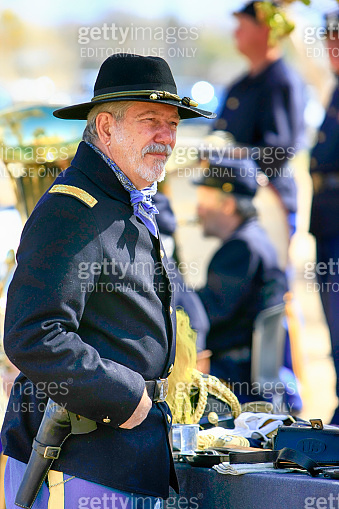 One man dressed in the uniform of an 1880s US Army cavalry Officer at ...