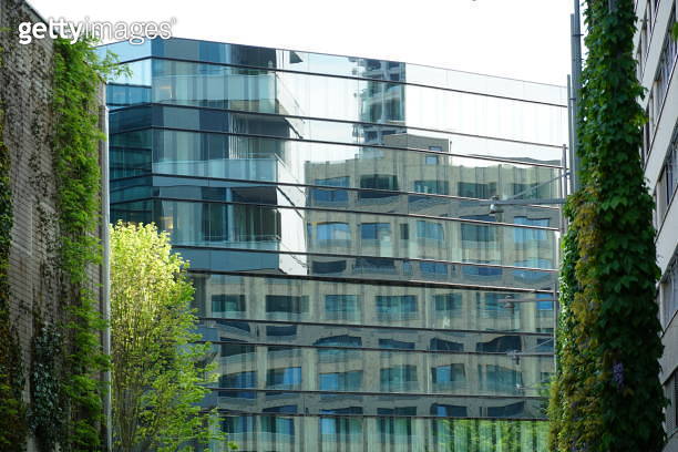 two modern buildings in perpendicular position, one consisting only of ...