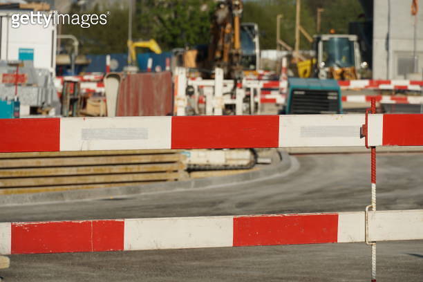 barrier planks in red and white securing construction equipment ...