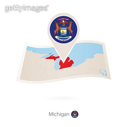 Folded paper map of Michigan U.S. State with flag pin of Michigan. 이미지 ...