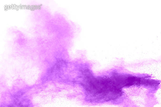 Closeup of purple dust particles splash on background.Purple color ...