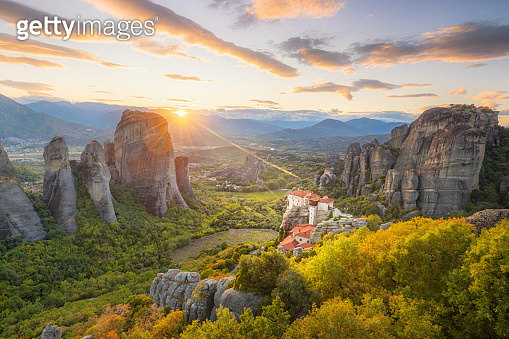 Landscape of Meteora, Greece at romantic sundown time with real sun and ...