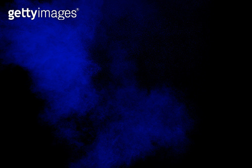 Blue powder explode cloud on black background.Launched blue dust ...