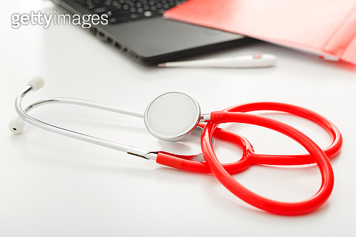 Doctor appointment. Thermometer, red stethoscope and medical documents ...