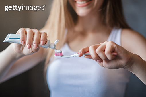 Dental hygiene. Unrecognizable young girl applying paste on her ...