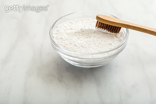 Bamboo toothbrush, dentifrice tooth powder on white marble background ...
