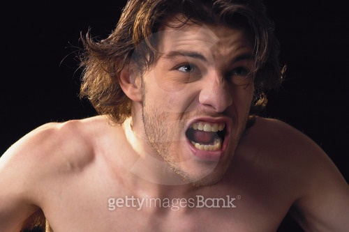 Close-up of a young man growling 이미지 (a7314995) - 게티이미지뱅크