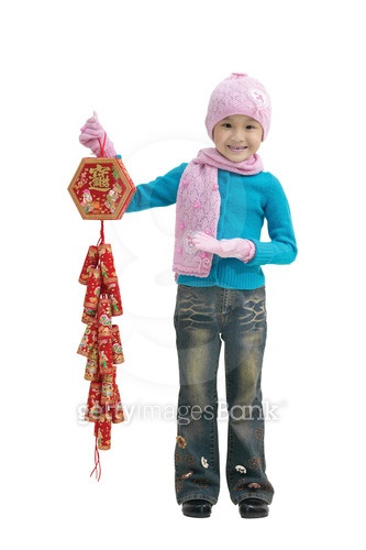 Portrait of a girl holding a string of crackers and smiling (a7336429 ...
