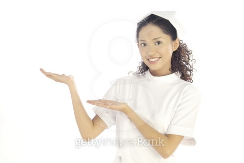 Portrait of a nurse holding her hands out and smiling (a7362345) - 게티이미지뱅크