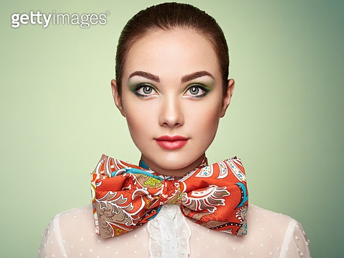 Portrait of beautiful young woman with bow 이미지 (a10714618) - 게티이미지뱅크