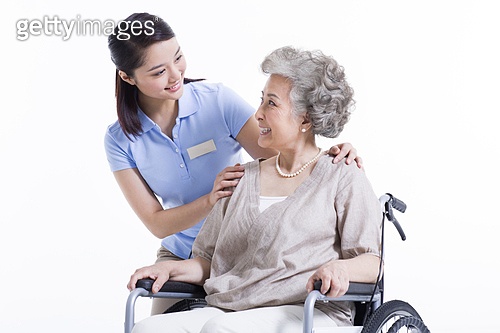 Female nursing assistant taking care of senior in wheelchair 이미지 ...