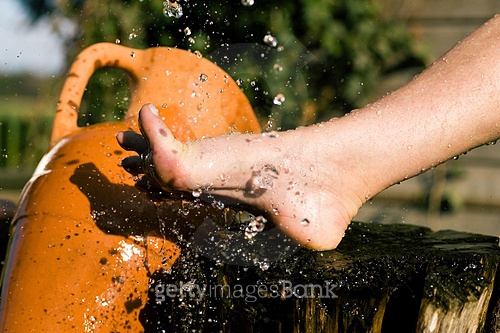 Splash of cold water showered on feet in an alternative therapy session ...