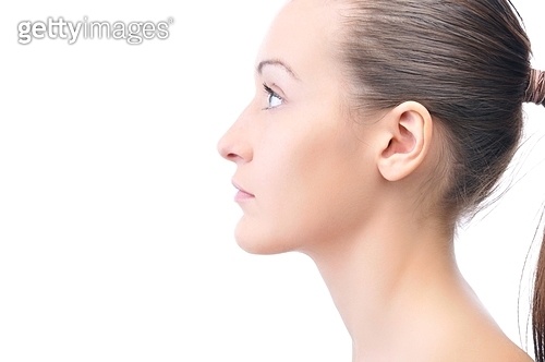 happy beautiful young woman is looking sideways isolated on white ...