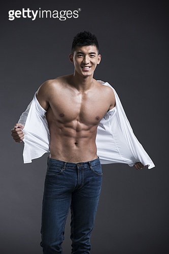 Portrait of young Chinese muscular man (a11095076) - 게티이미지뱅크
