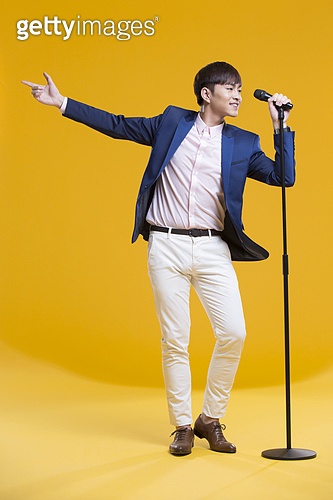 Cheerful young Chinese man singing with microphone 이미지 (a11095382) - 게티 ...