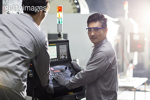 Confident Chinese engineers working in the factory 이미지 (a11095899) - 게티 ...