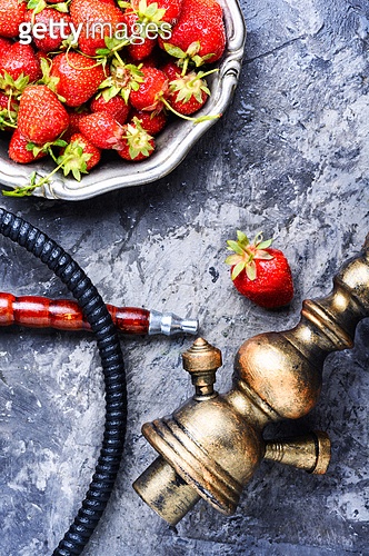 Stylish oriental shisha with strawberry. Oriental hookah with the aroma ...
