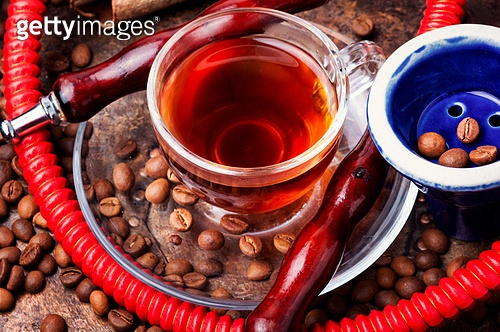 Stylish coffee cup with coffee and hookah mouthpiece.Arabian shisha and ...