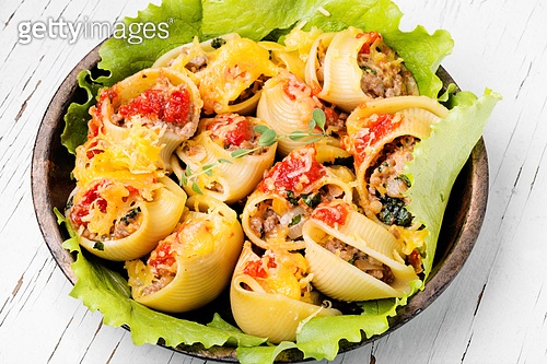 Italian style stuffed pasta shells with meat on a white background ...