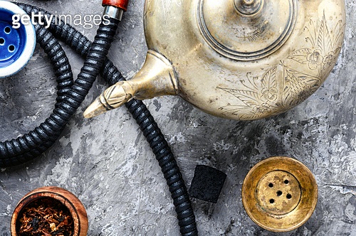 East smoking hookah. Arabian shisha with tea. Hookah and tea.Cooking ...