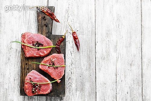 Raw meat beef. raw chops veal steak with peppers and spices (a11912570 ...