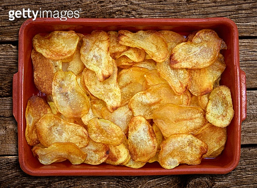 Homemade fried potatoes sliced chips in a clay pot 이미지 (a11922438) - 게티 ...
