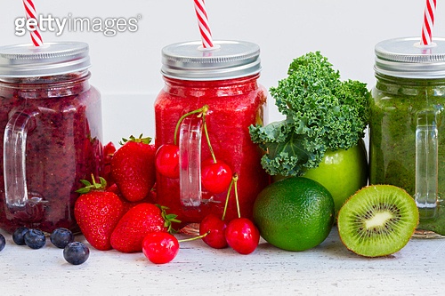 Colorful smoothy drinks in jars with igredients close up. Fresh smoothy ...