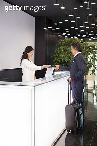 Chinese receptionist giving business card to businessman 이미지 (a12300473 ...