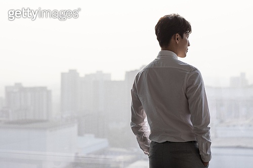 Successful Chinese businessman standing in front of window 이미지 ...