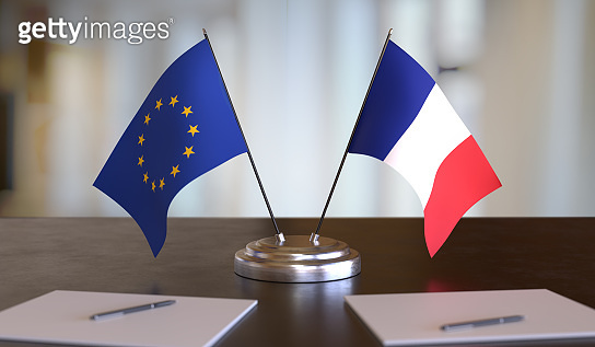 French and EU flags on table. Negotiation between European Union and ...