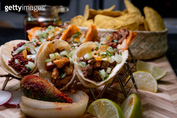 Authentic Street Food mixed tacos plated and ready to serve with salsa ...