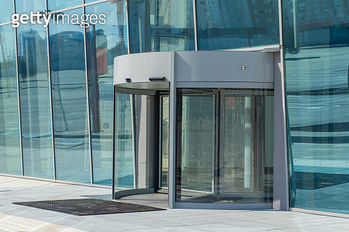 Revolving carousel rotary doors at entrance to building of shopping ...